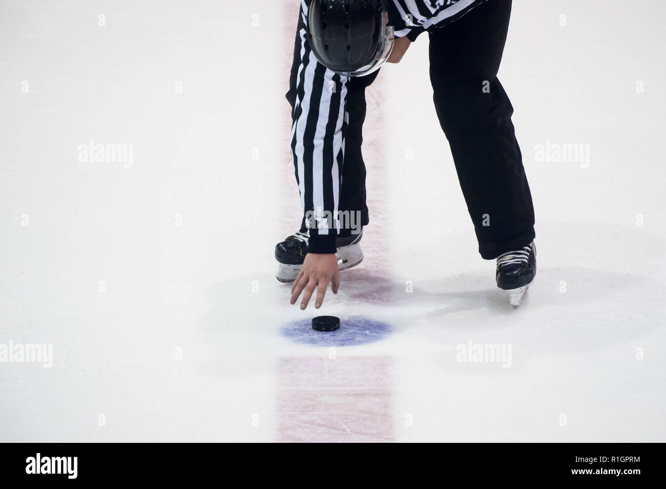 Ice Hockey referee a puck in your hand Stock Photo - Alamy