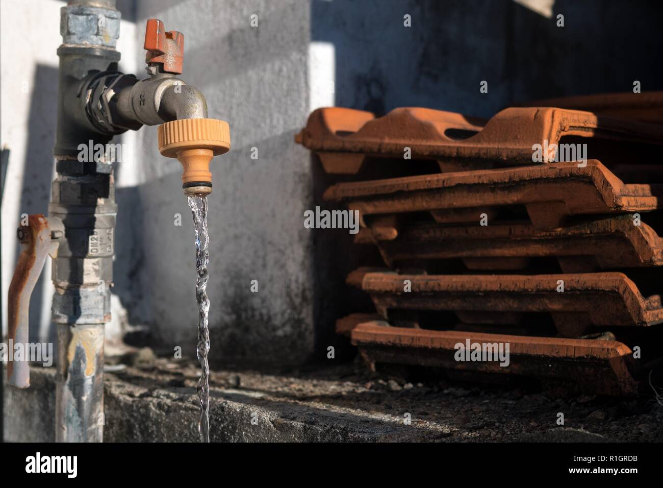 Water tap and roof tiles Stock Photo - Alamy