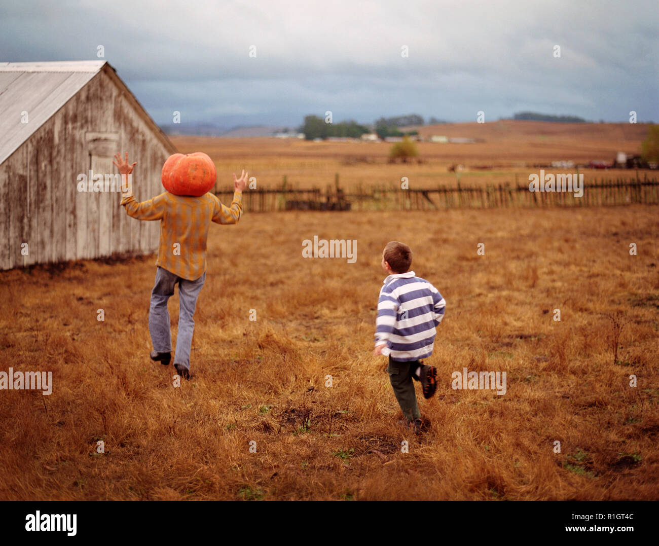 Man dancing around a field with his son while wearing a hollowed ...