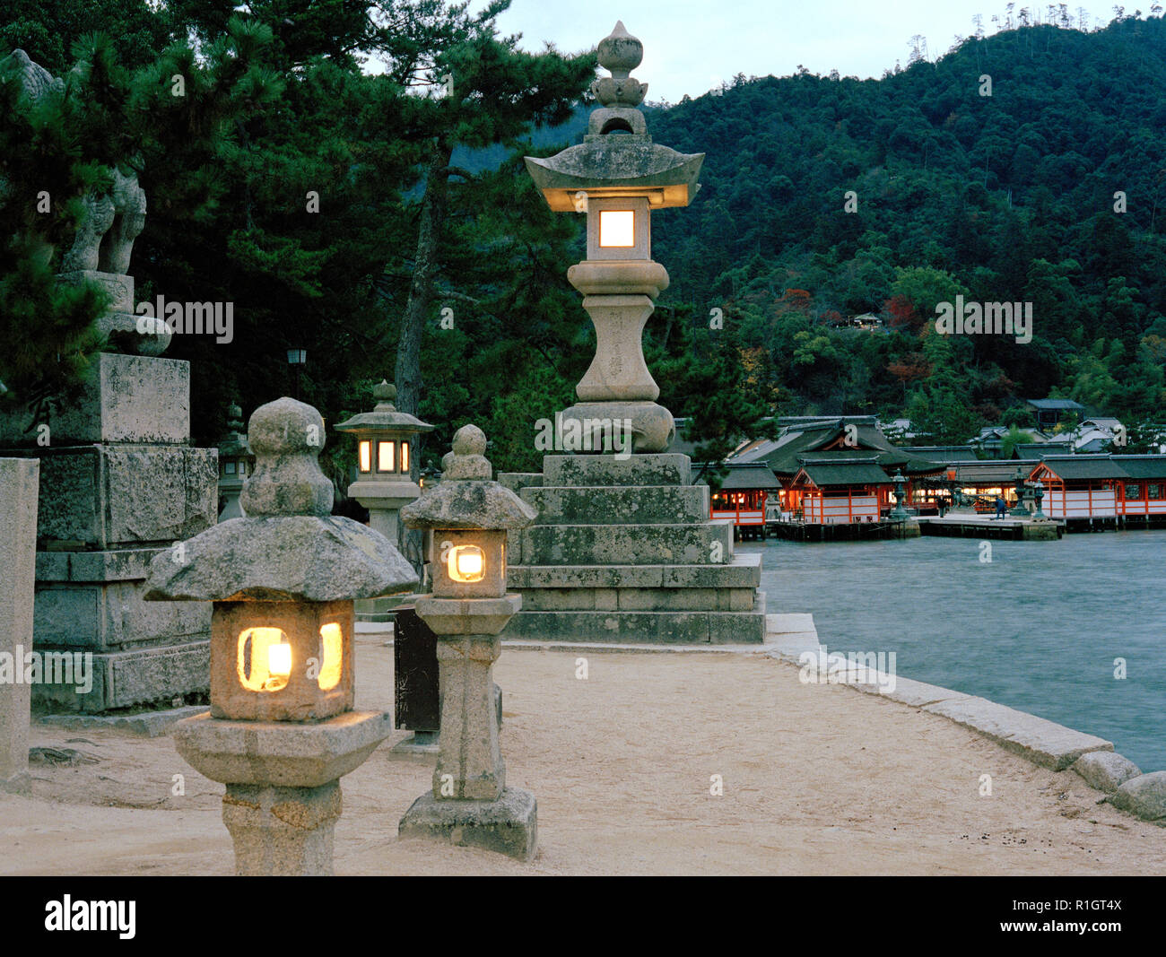 Illuminated old stone lanterns on a waterfront Stock Photo - Alamy