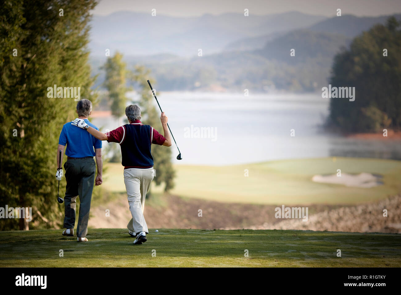 Two mature men enjoying a game together on a golf course Stock Photo ...