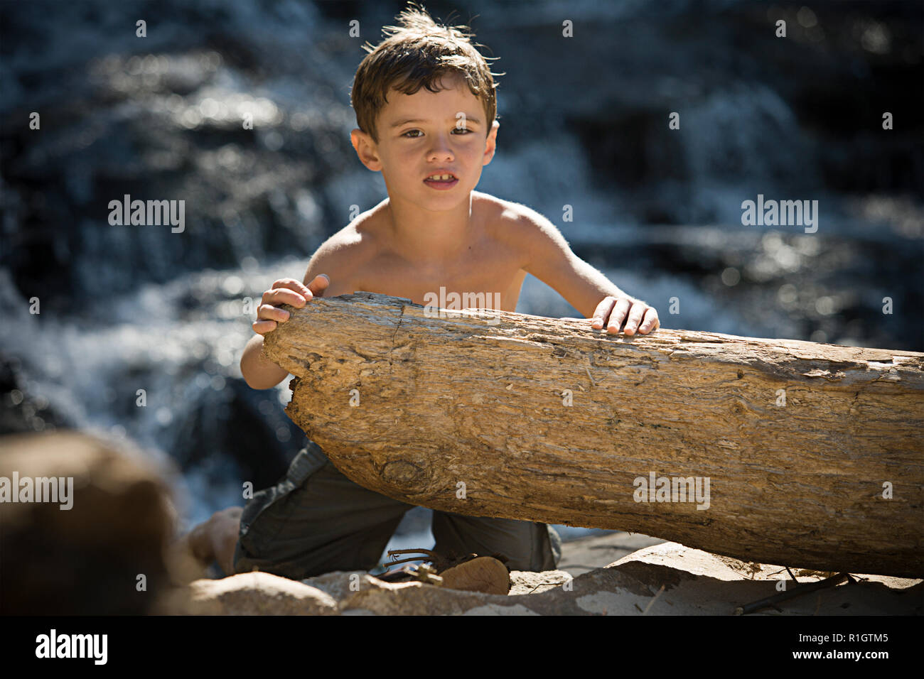 Boy climbing rocks Stock Photo - Alamy