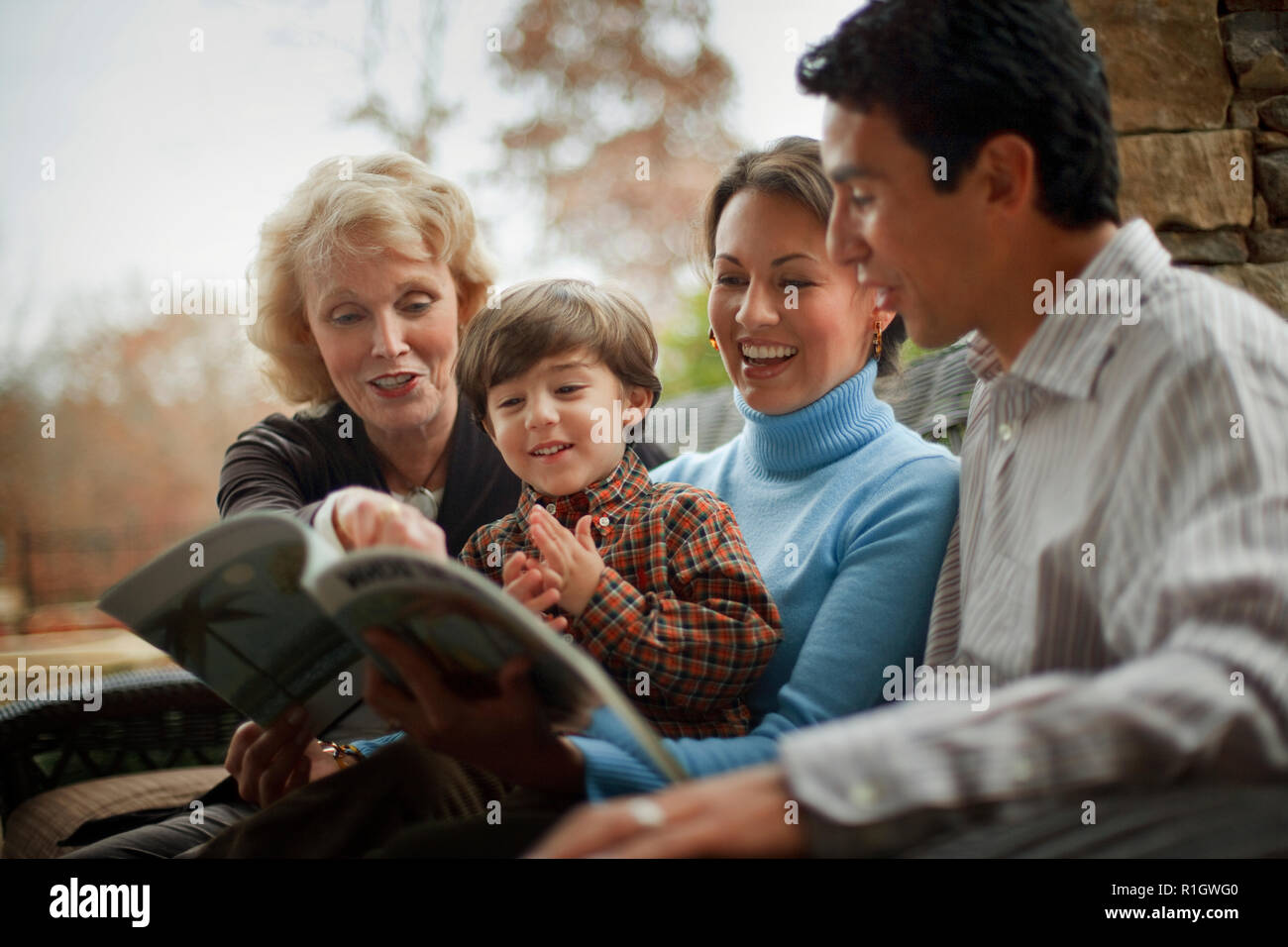 Family reading story together Stock Photo - Alamy