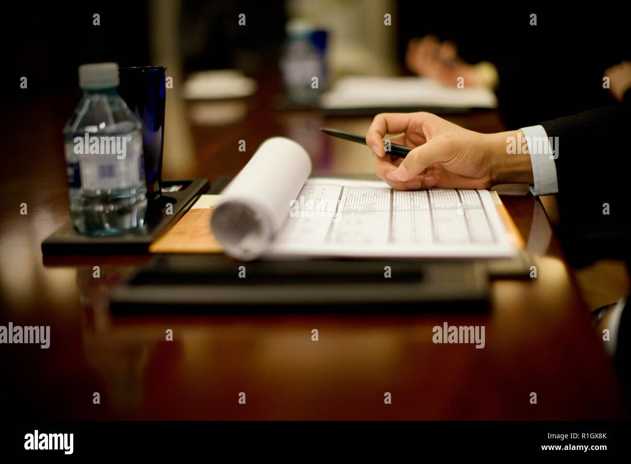 Notes being taken by people in a boardroom Stock Photo - Alamy