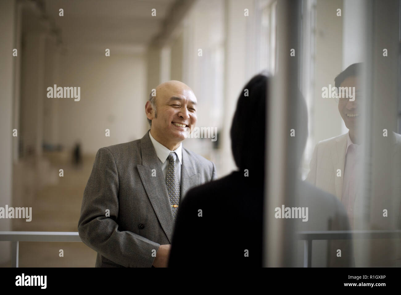 Senior adult businessman talking with colleagues in an office Stock ...