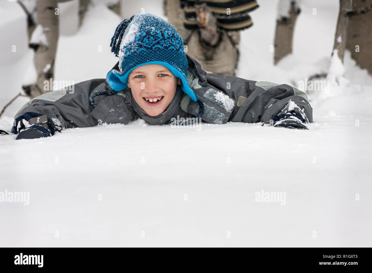 Portrait of a young boy lying on his front Stock Photo - Alamy