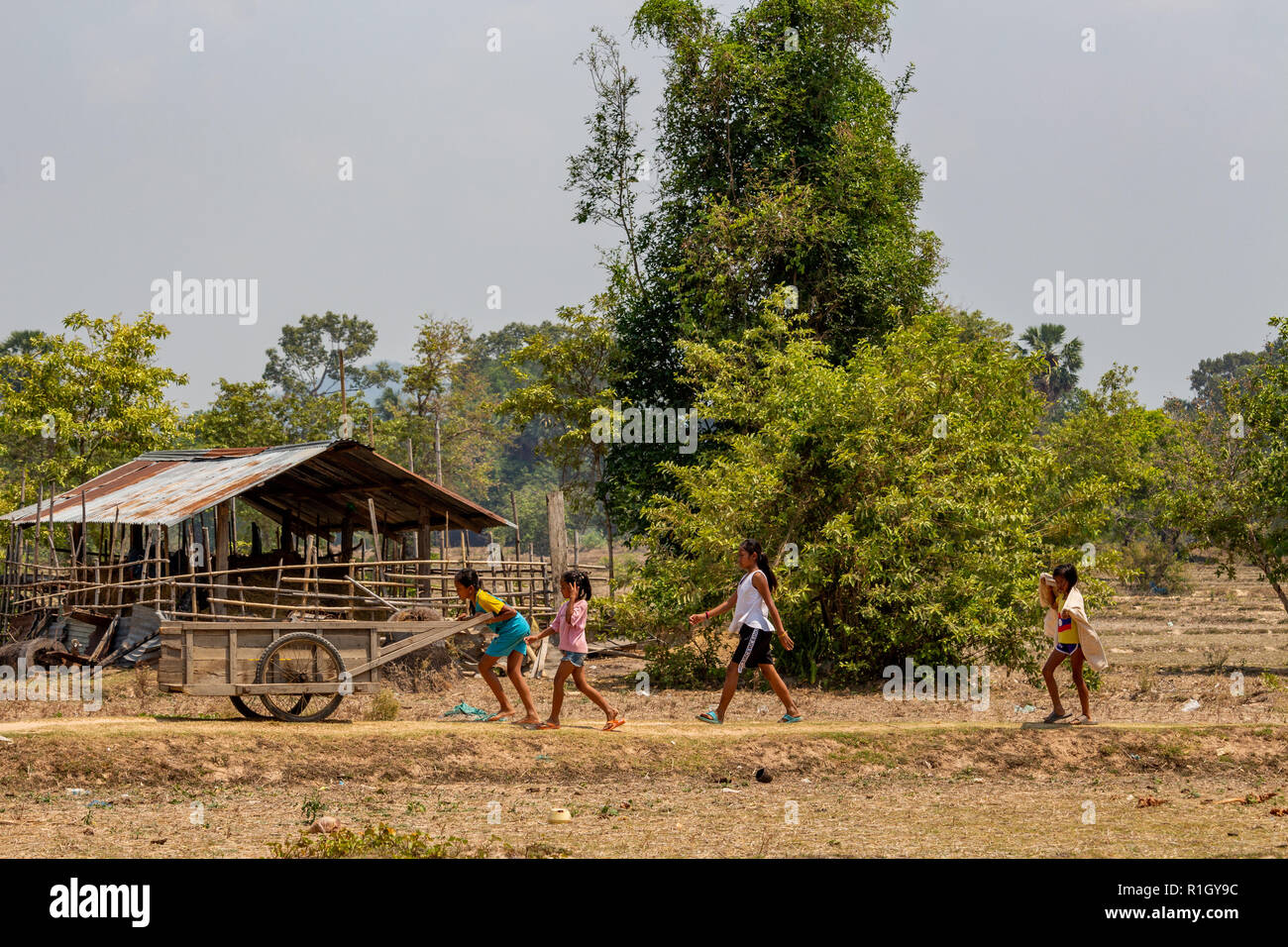 Don Det, Laos - April 22, 2018: Local children playing driving a wooden ...