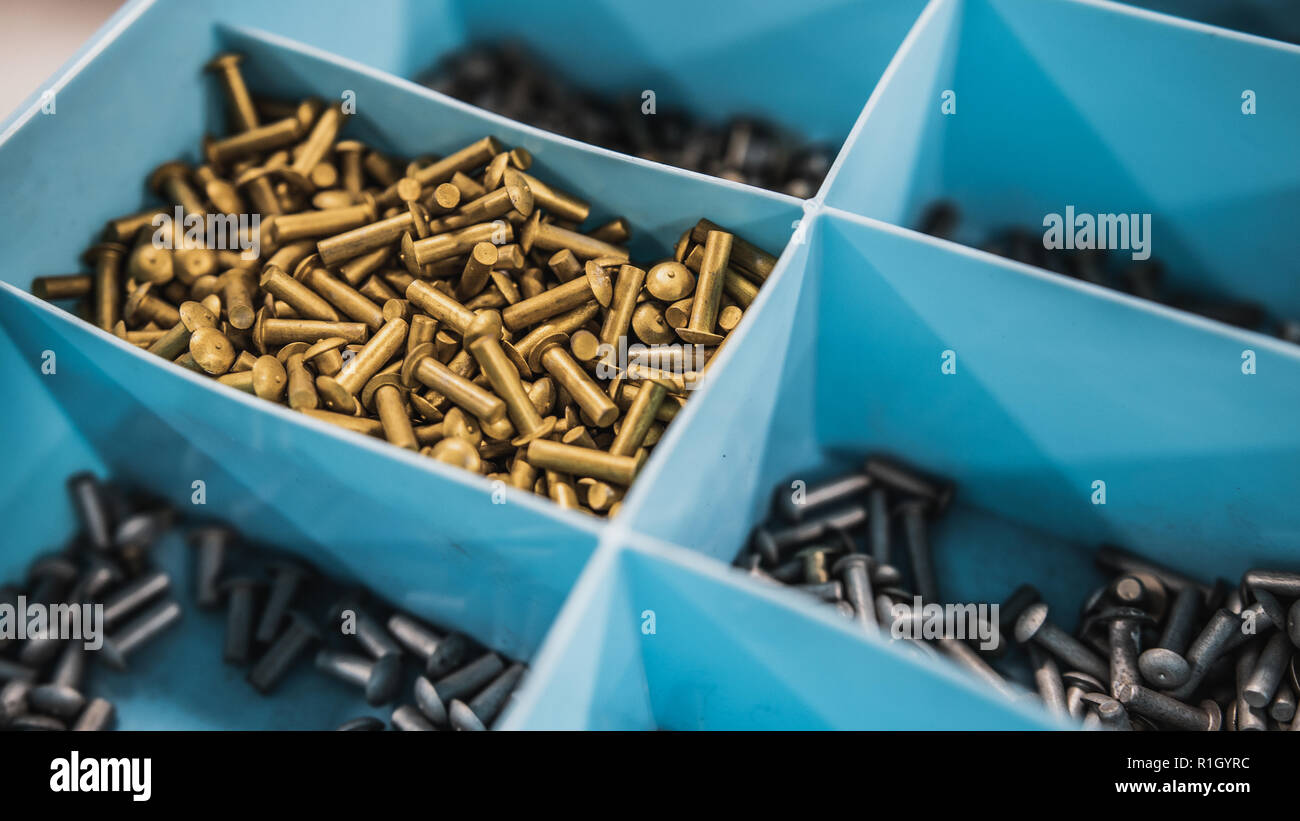 Bunch of golden and silver screws used in aircraft maintenance class ...