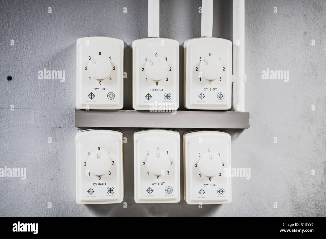 Six fan switch with three selectable power output on a white wall with ...