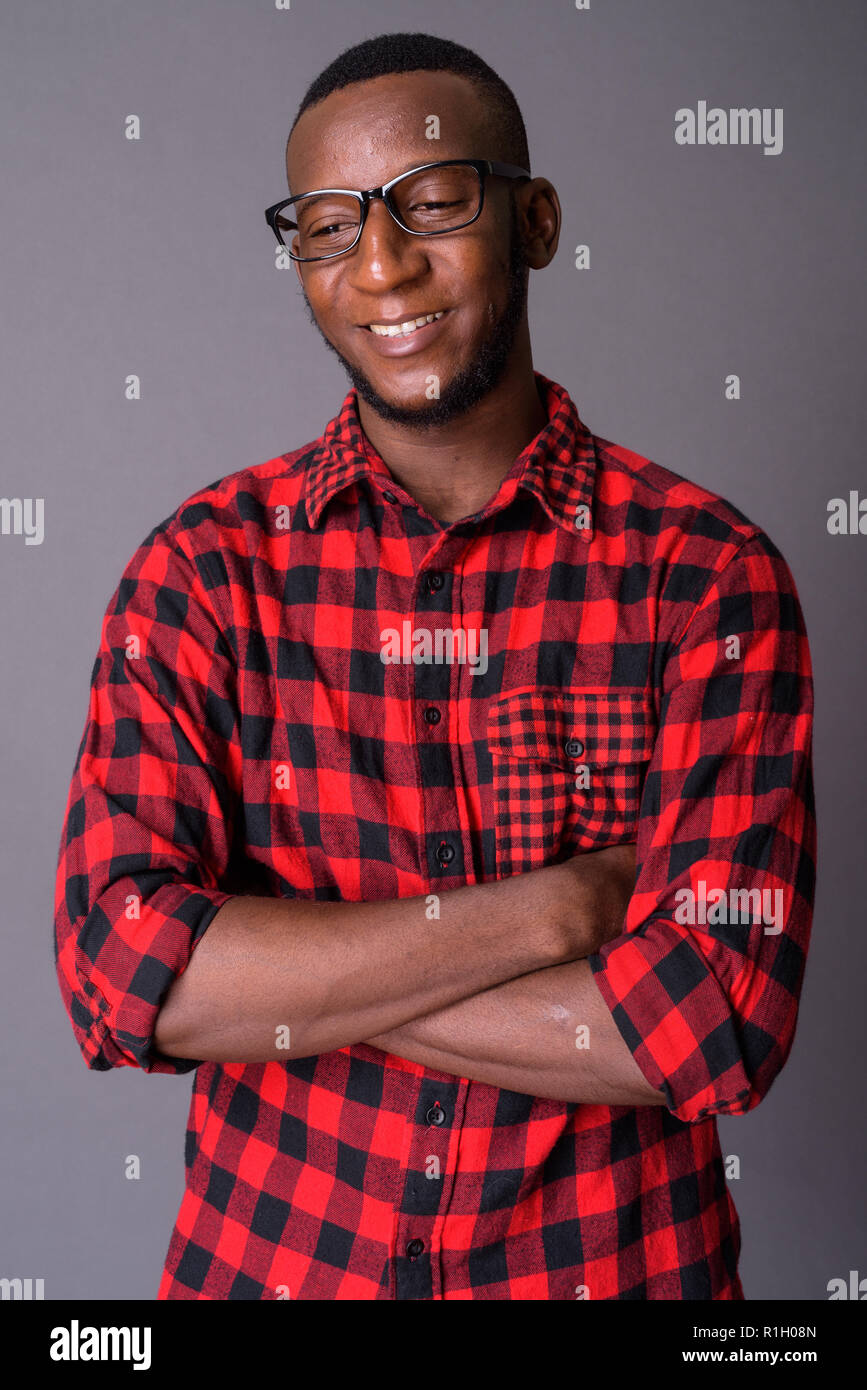 Young handsome African man with short hair against gray backgrou Stock ...