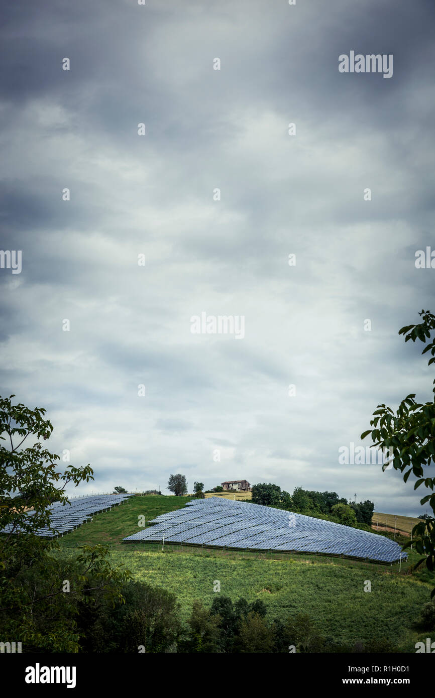 An array of solar panels (solar farm) on a hillside in Le Marche, Italy ...