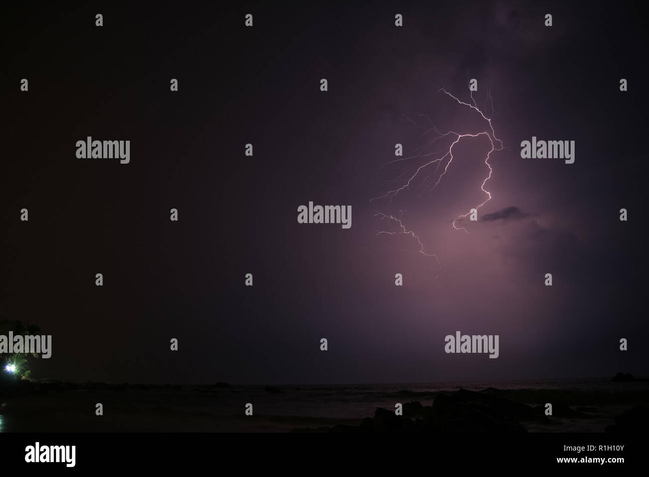 Small lightning strike in sky at clouds Stock Photo - Alamy