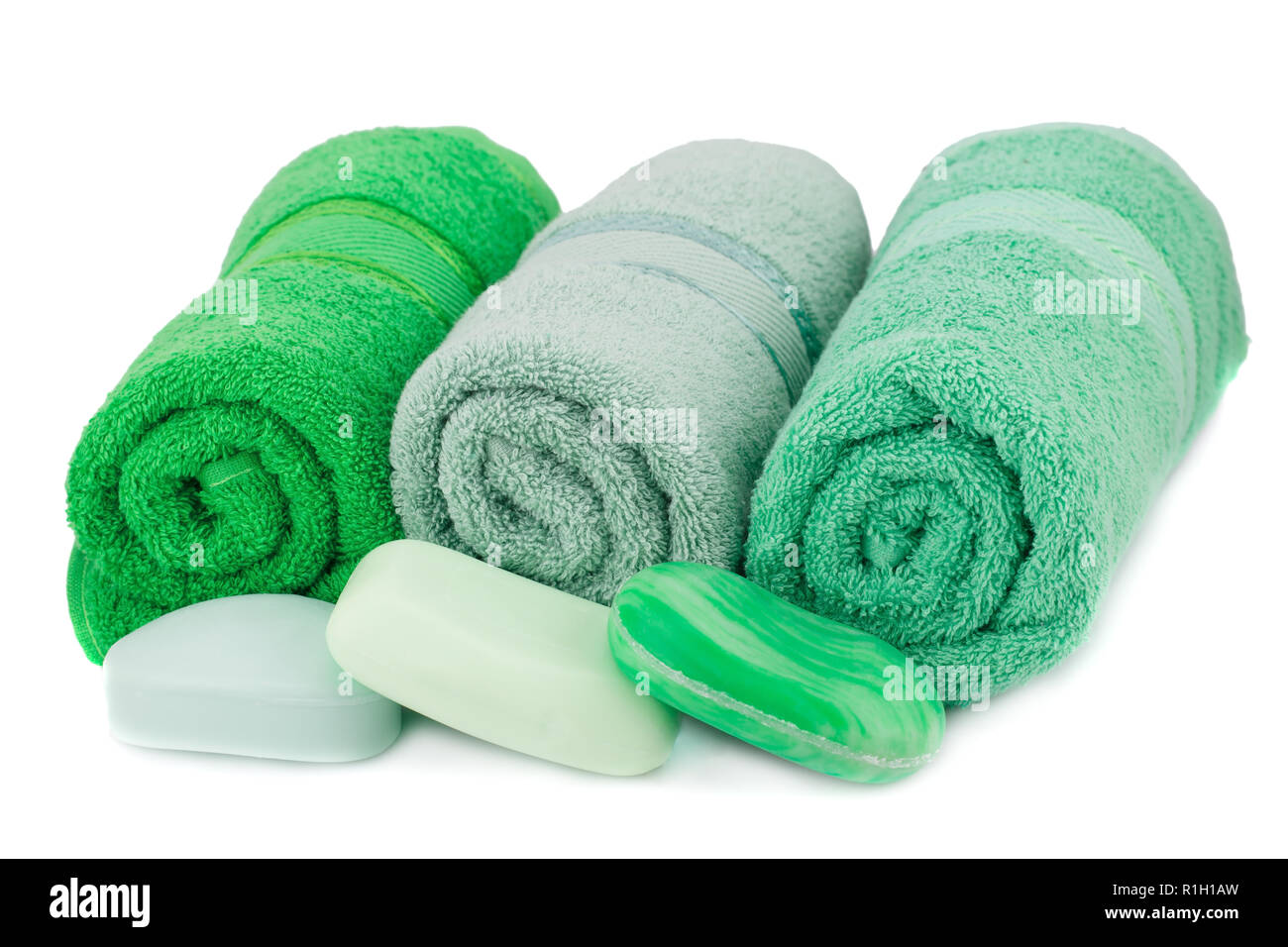Rolled green towels and soaps isolated on white background Stock Photo ...