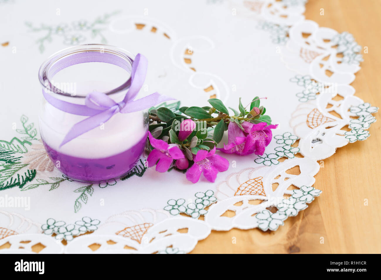 Beautiful candle and pink flowers on cloth background Stock Photo - Alamy