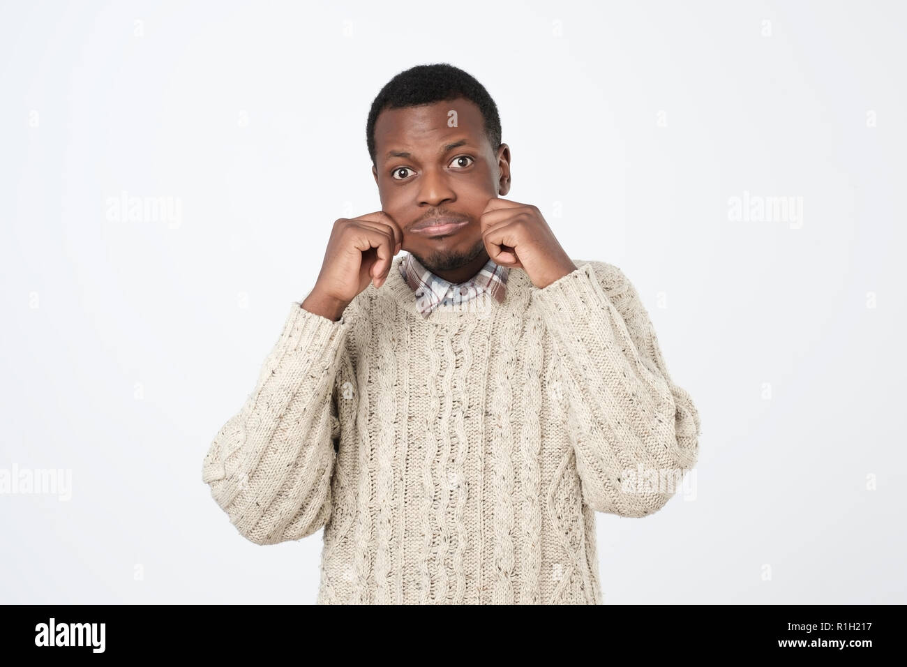 portrait of young african man stretching out his cheeks and skin Stock ...