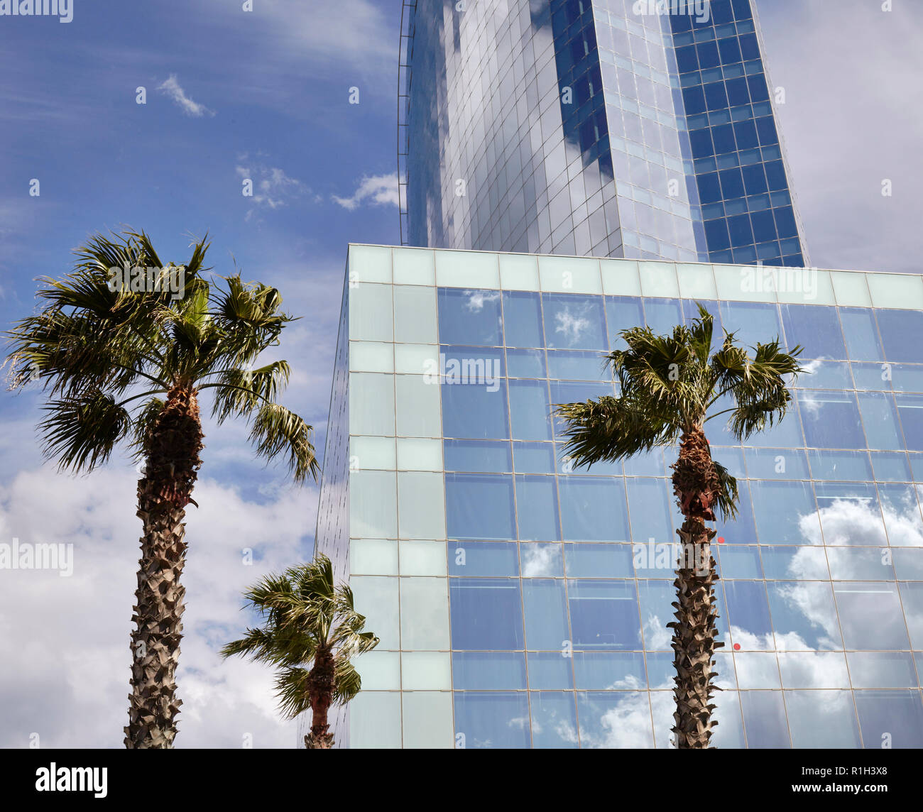 The shiny front of a modern hotel building against a blue sky Stock ...