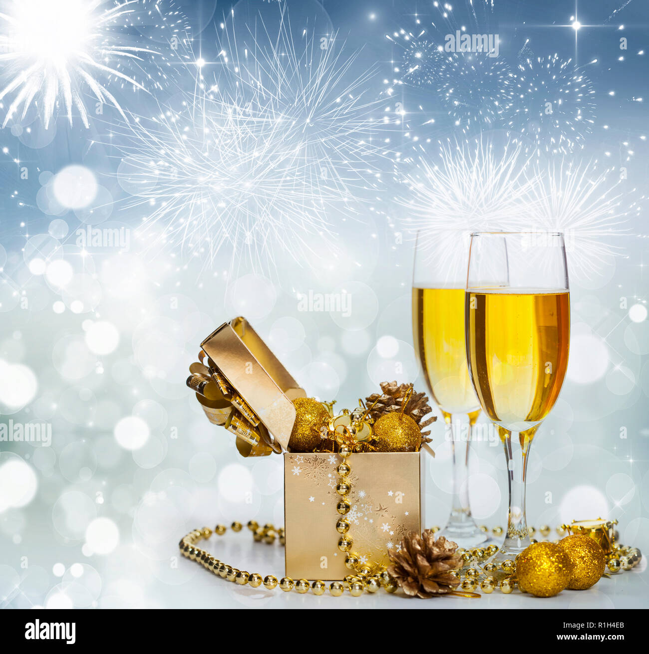 Glasses of champagne on sparkling holiday background with fireworks ...