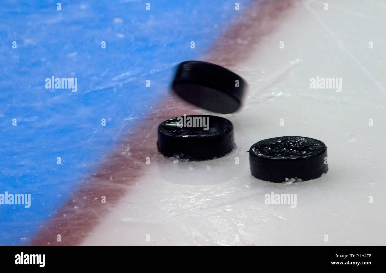 Hockey puck stand on side on goal line. Close view Stock Photo - Alamy