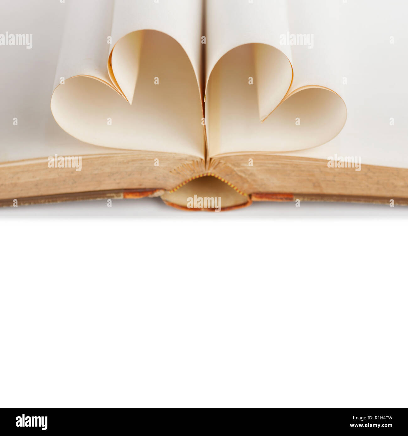 Pages of open book rolled in heart shape on glitter background Stock ...