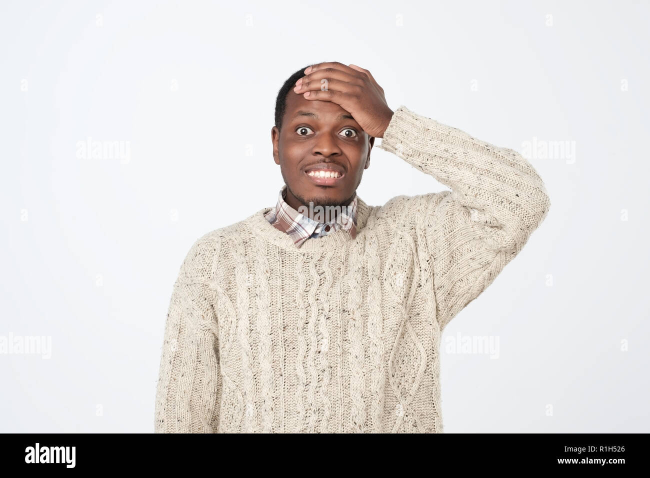 Surprised young handsome african guy with admire on his face put his ...