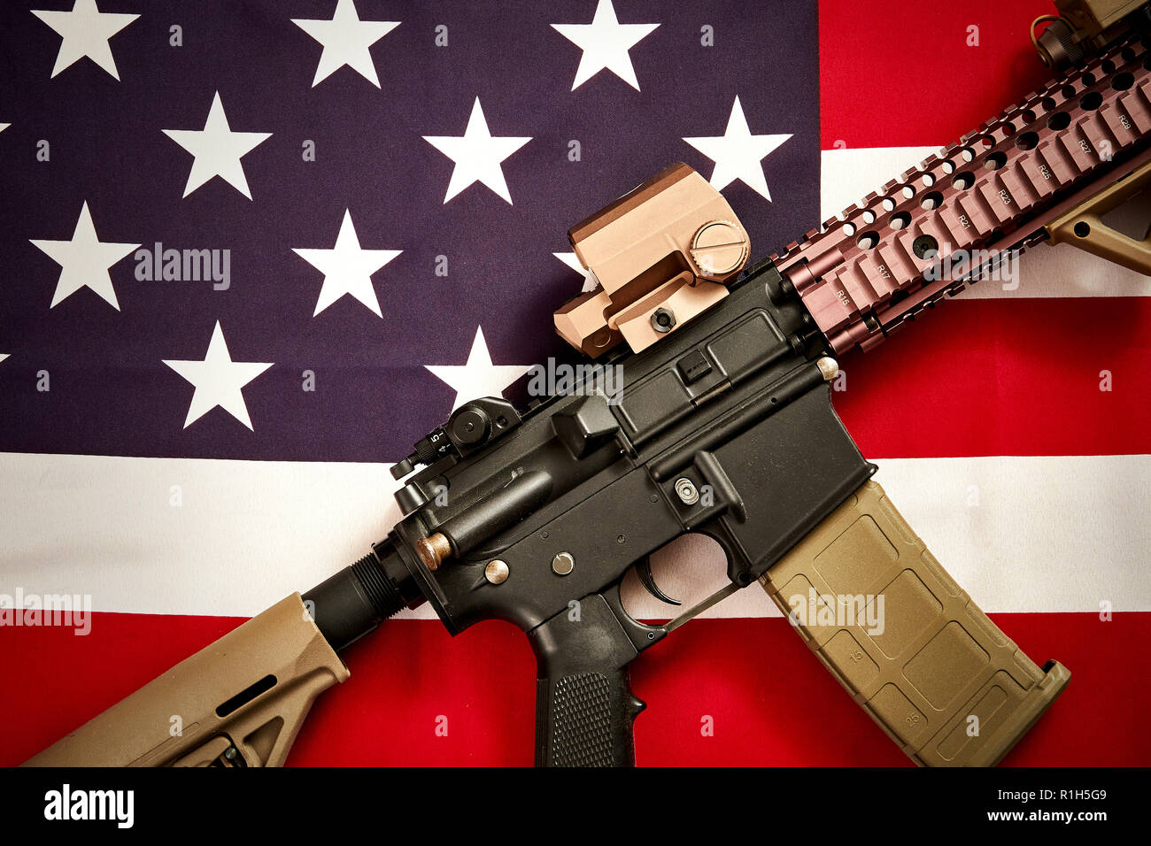top view of a machine gun set against the background of the USA flag ...
