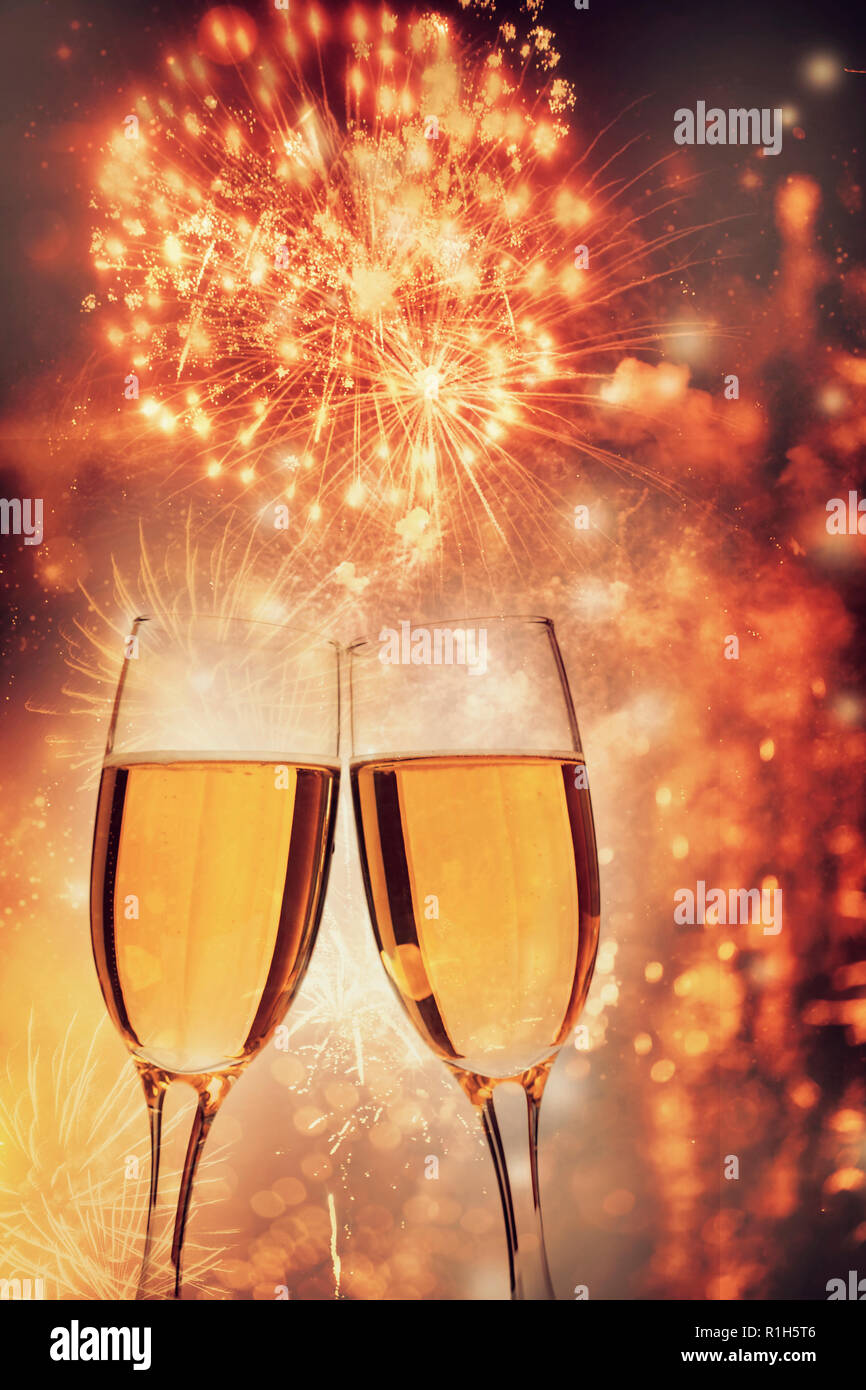 Glasses of champagne on sparkling holiday background with fireworks ...