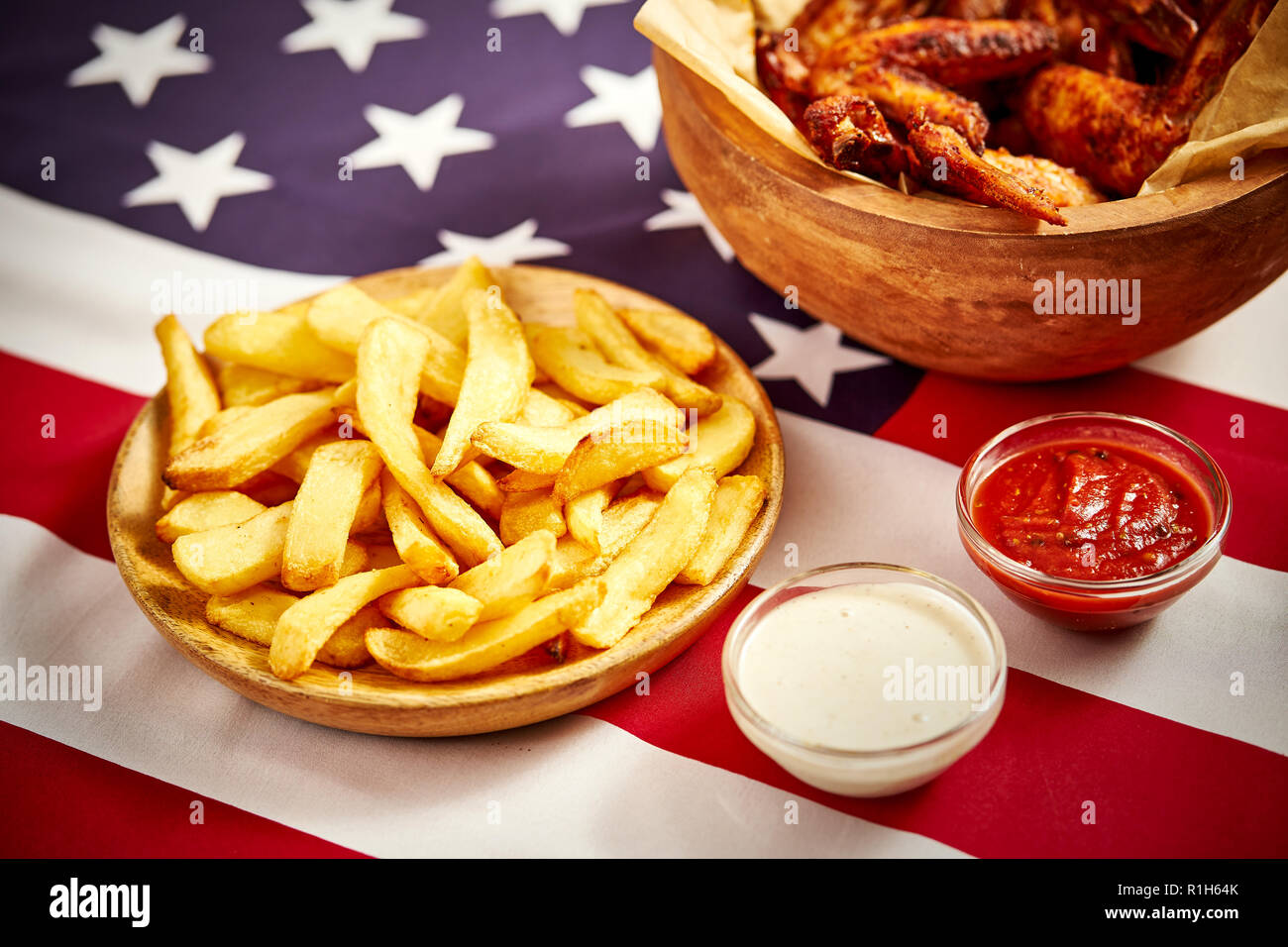 delicious fried chicken wings and french fries with background of the ...