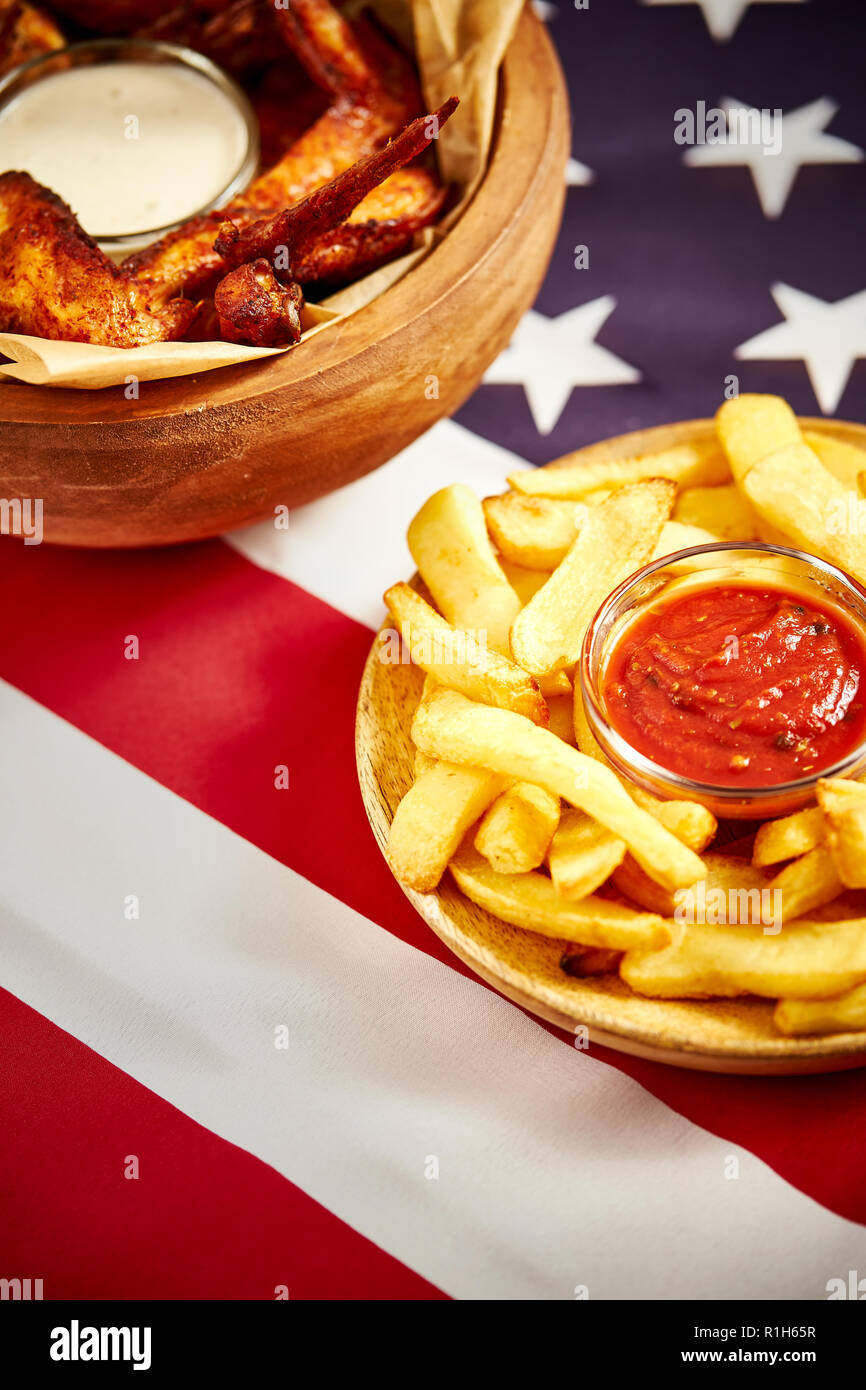 delicious fried chicken wings and french fries with background of the ...