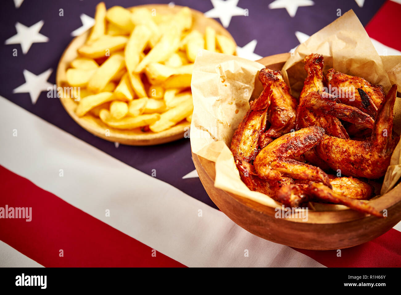 delicious fried chicken wings and french fries with background of the ...