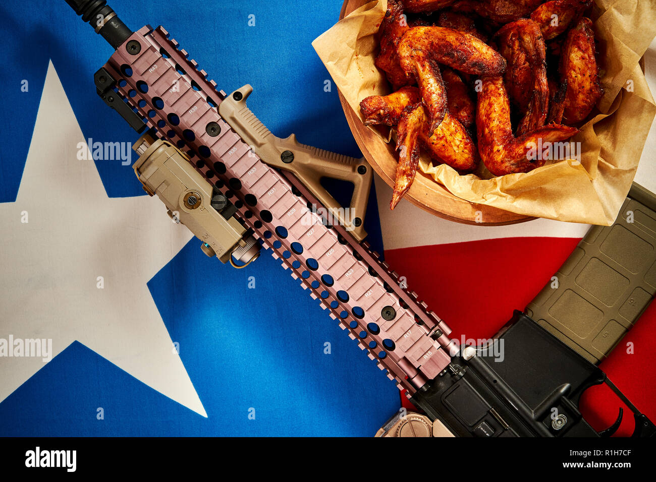 top view of delicious fried chicken wings and machine gun against texas ...