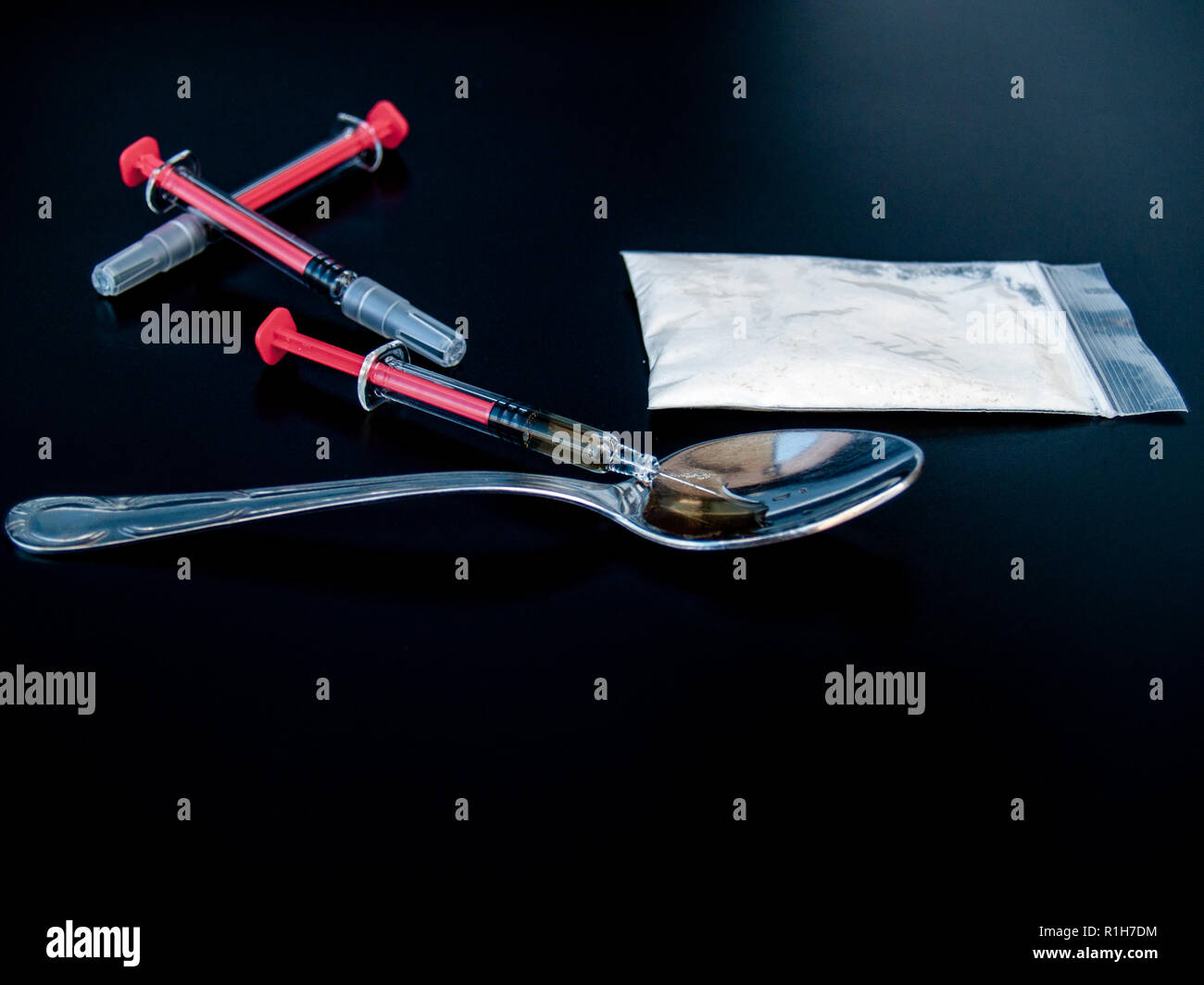 Drug, one spoon, and syringes with black background. Drug concept Stock ...