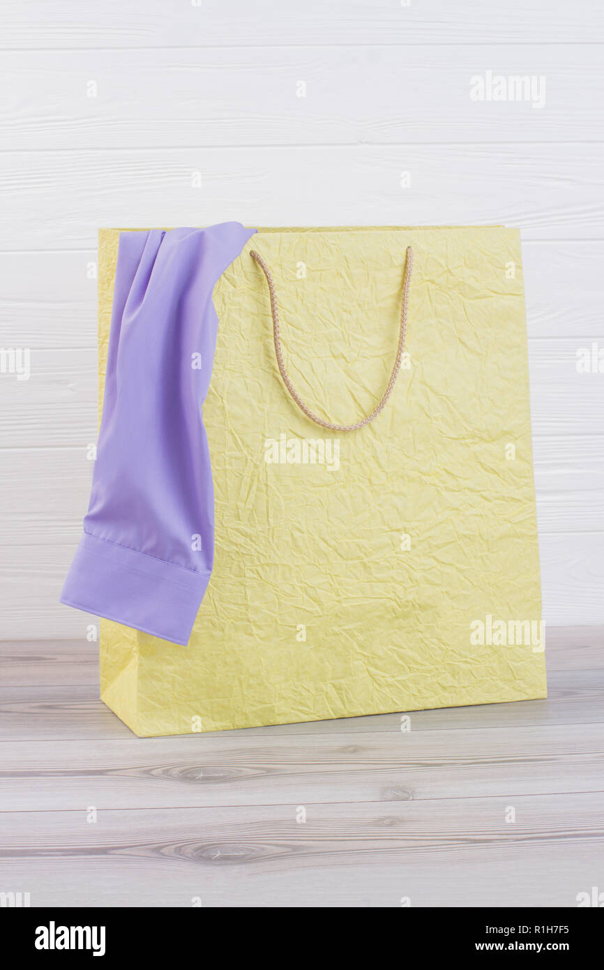 Yellow shopping bag with purchase Stock Photo - Alamy