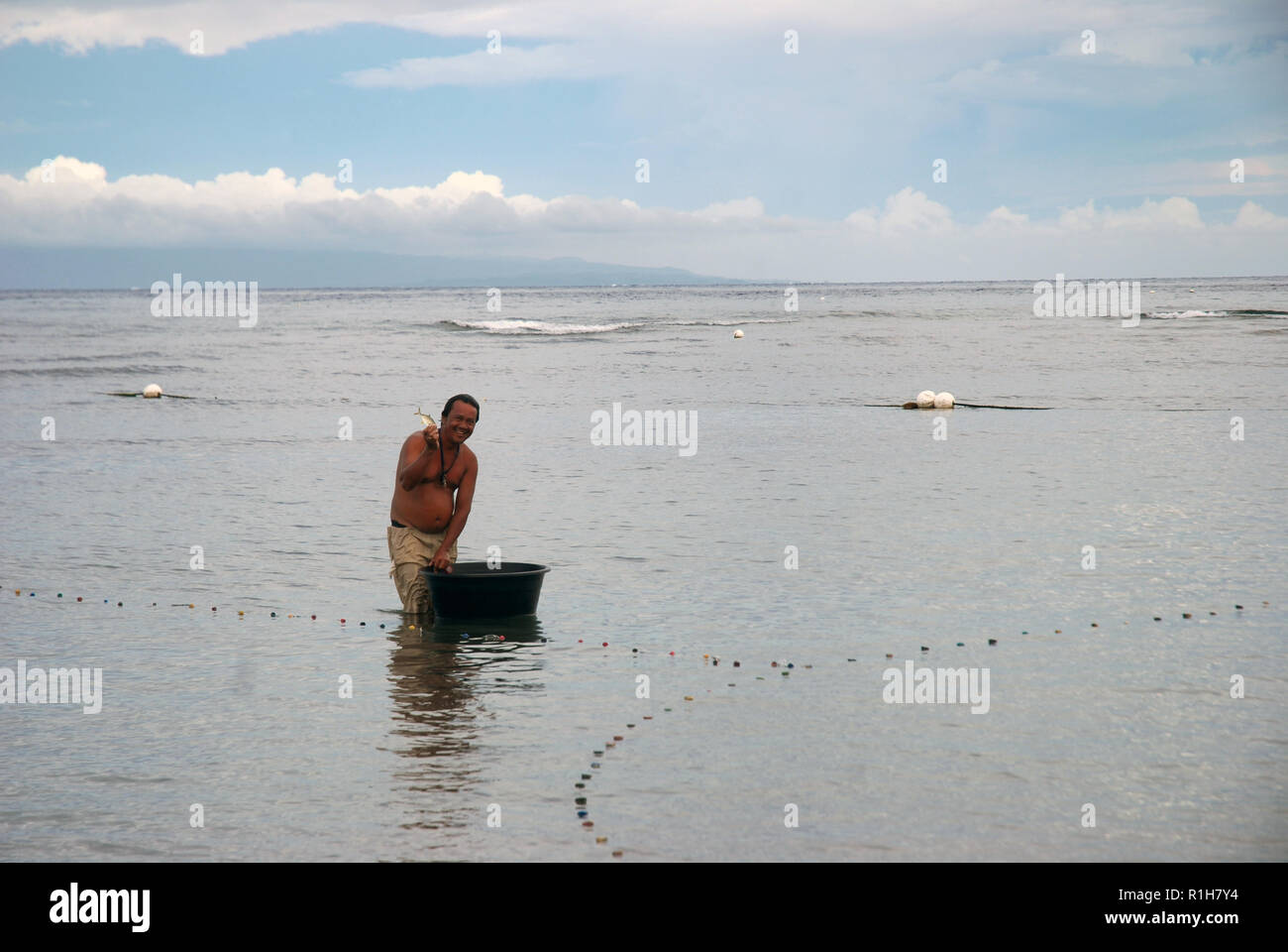 Man fishing in sea, Escano Beach, Dumaguete, Negros Oriental ...