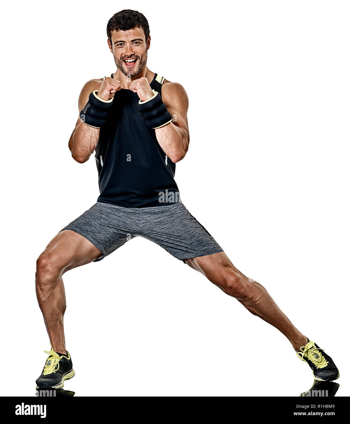 one caucasian fitness man exercising cardio boxing exercises in studio ...