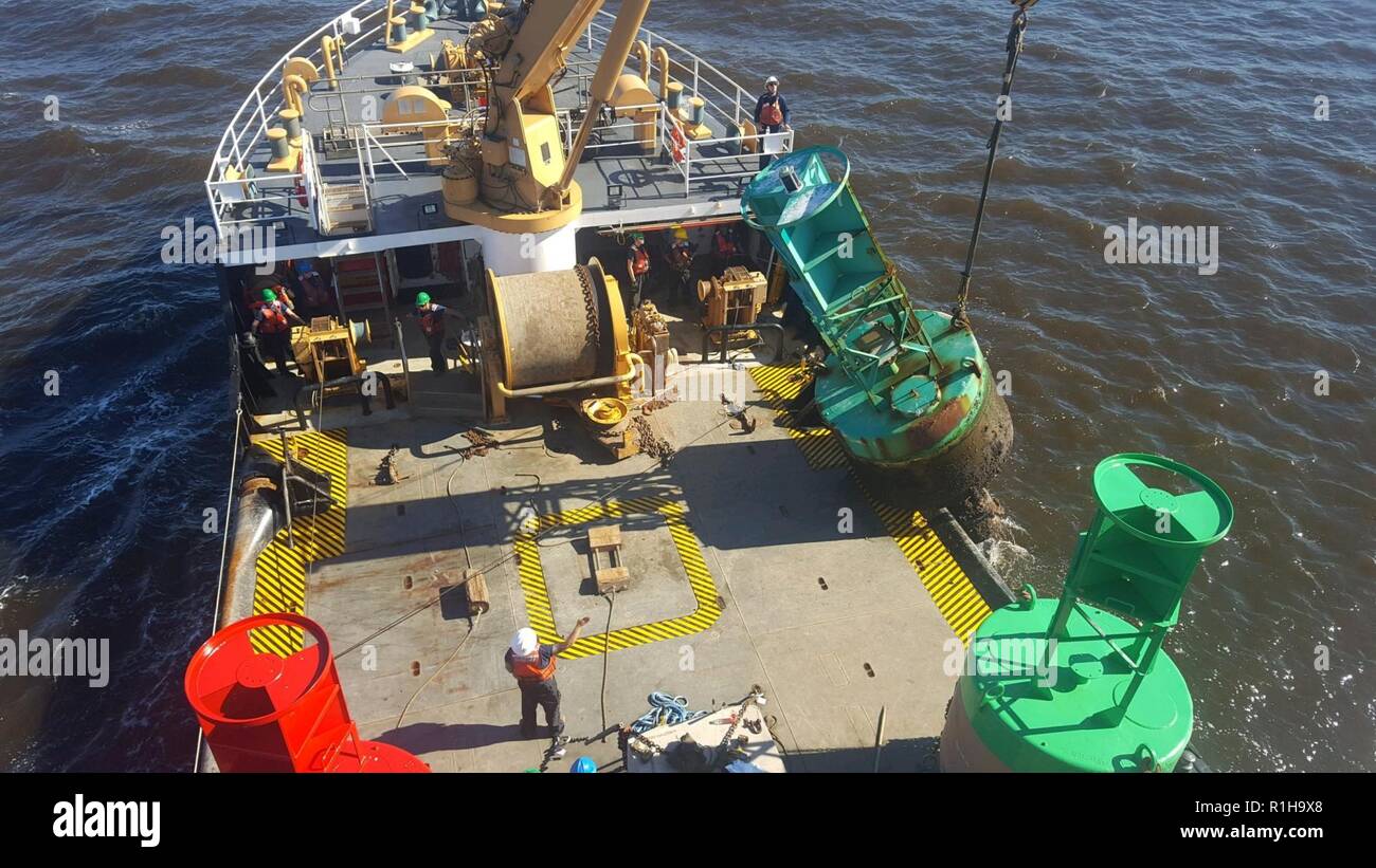 Crew members from Coast Guard Cutter Frank Drew reset buoys off the ...