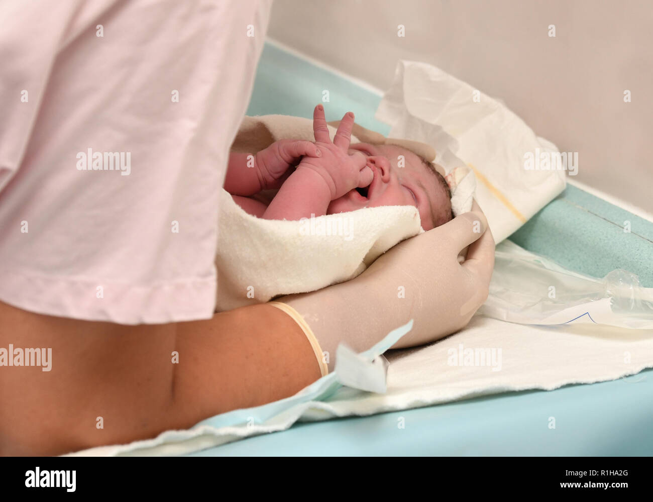 Nurse caring for newborn baby after childbirth Stock Photo - Alamy