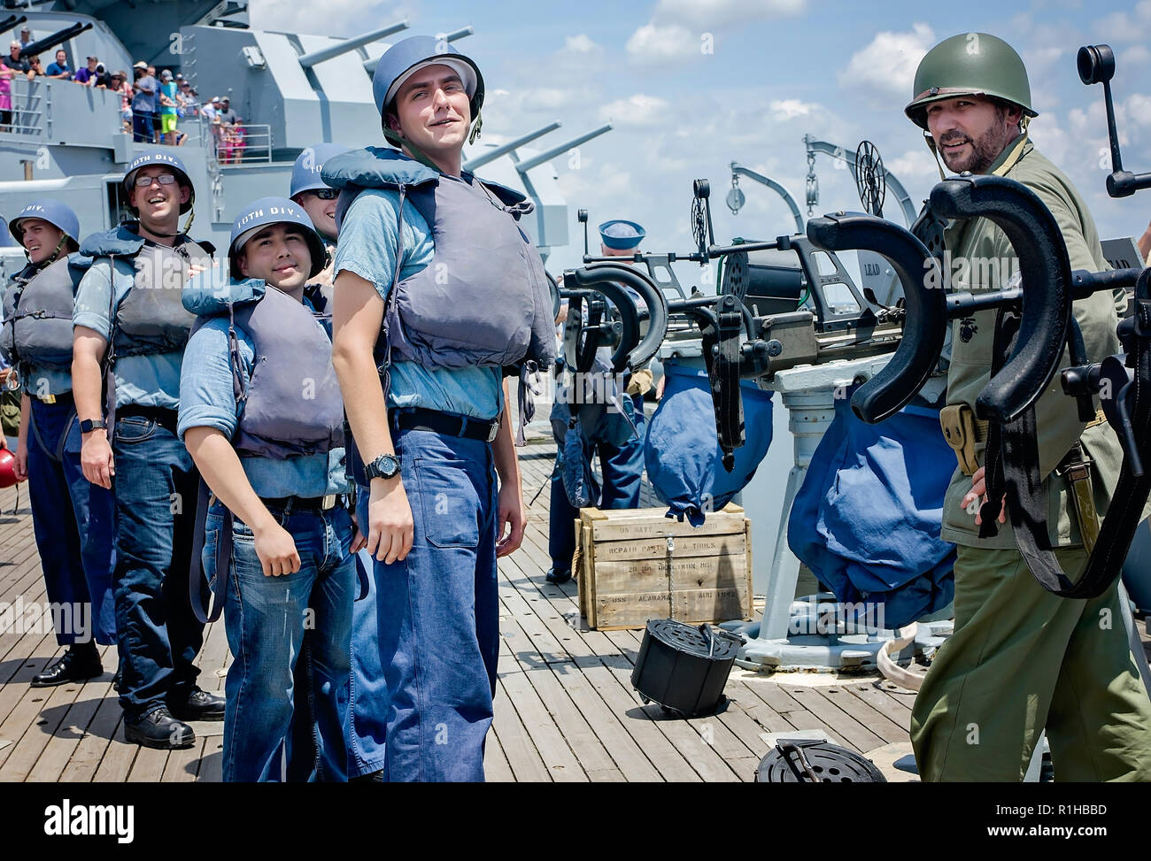 Members of the USS Alabama's Living History Crew watch as a crowd ...