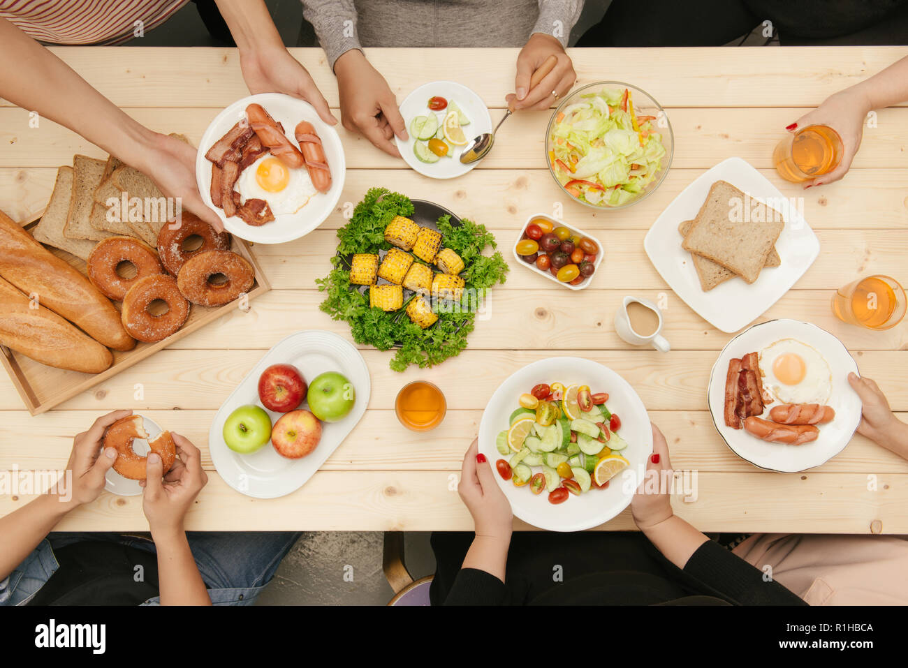 Enjoying dinner with friends. Top view of group of people having dinner ...
