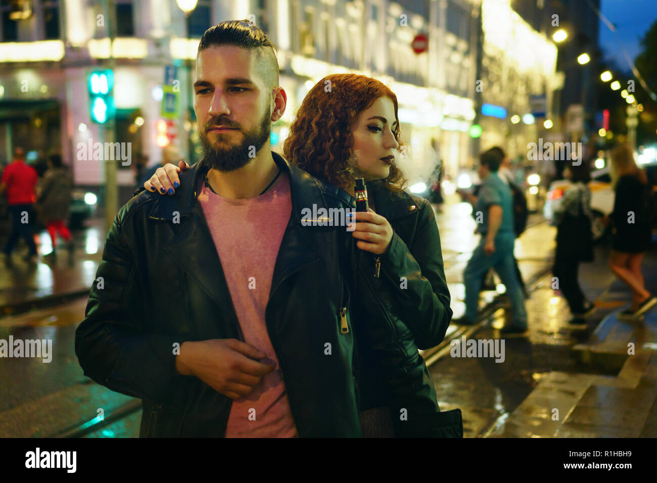 Couple in love on date. Boyfriend is ahead of her girlfriend. She hugs ...