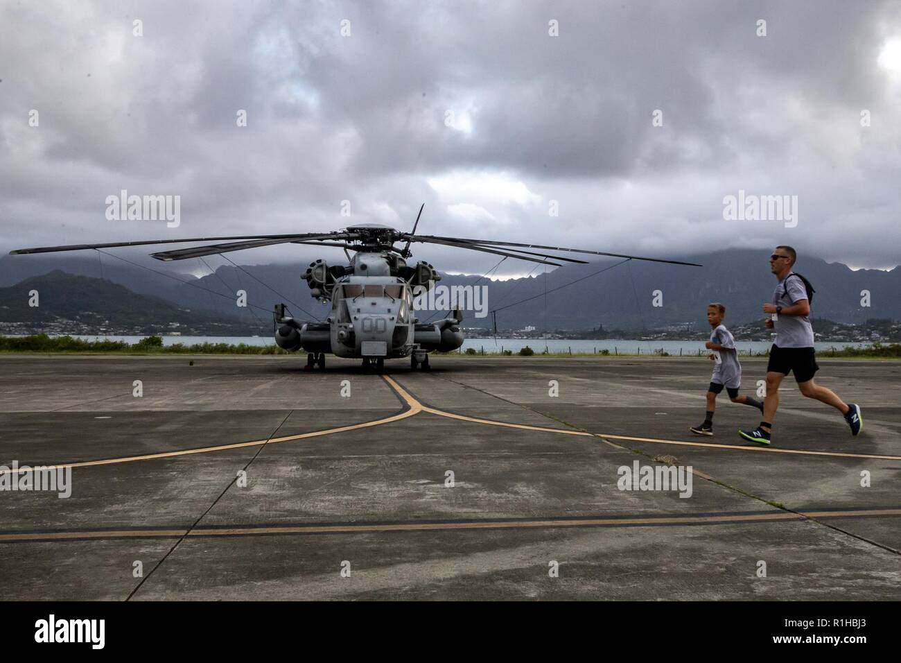 Participants run across the flight line aboard Marine Corps Air Station ...