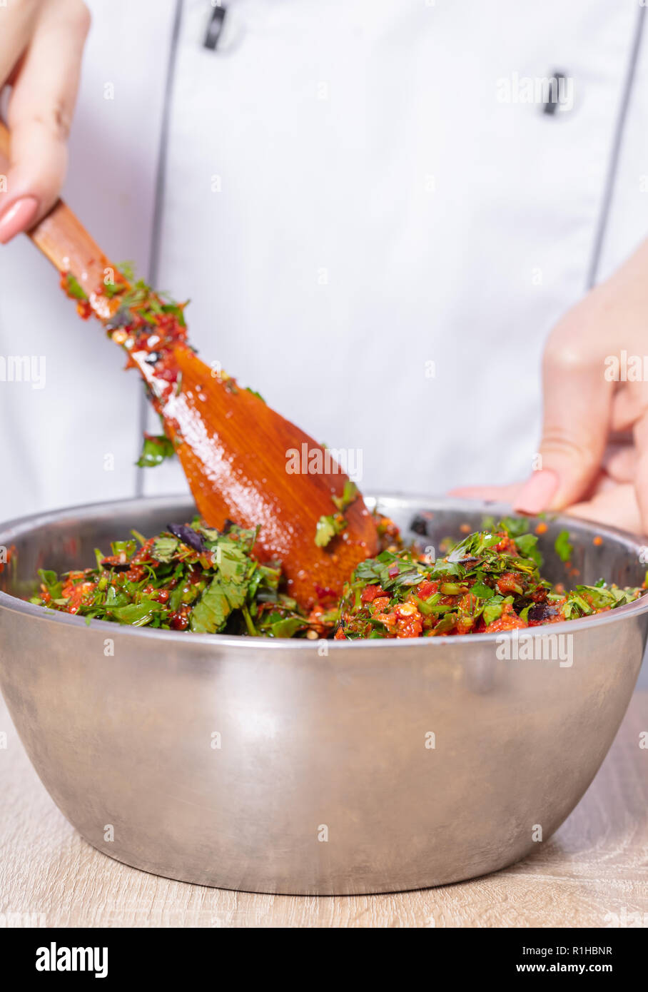 chef mixes the red hot peppers with aromatic herbs Stock Photo - Alamy