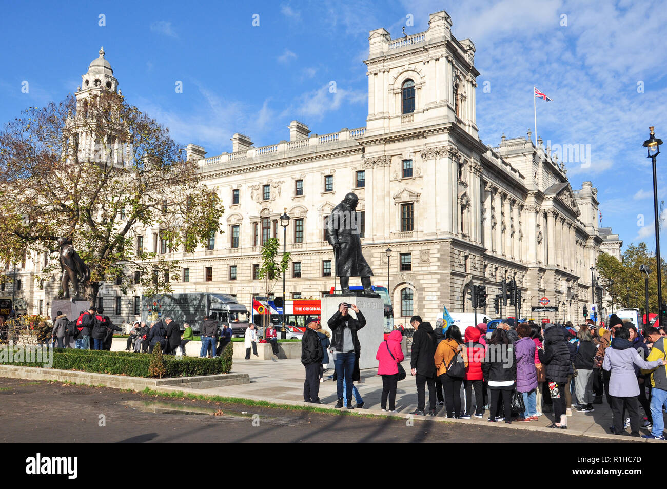 LONDON - Tourists at the statue of Winston Churchill in front of ...
