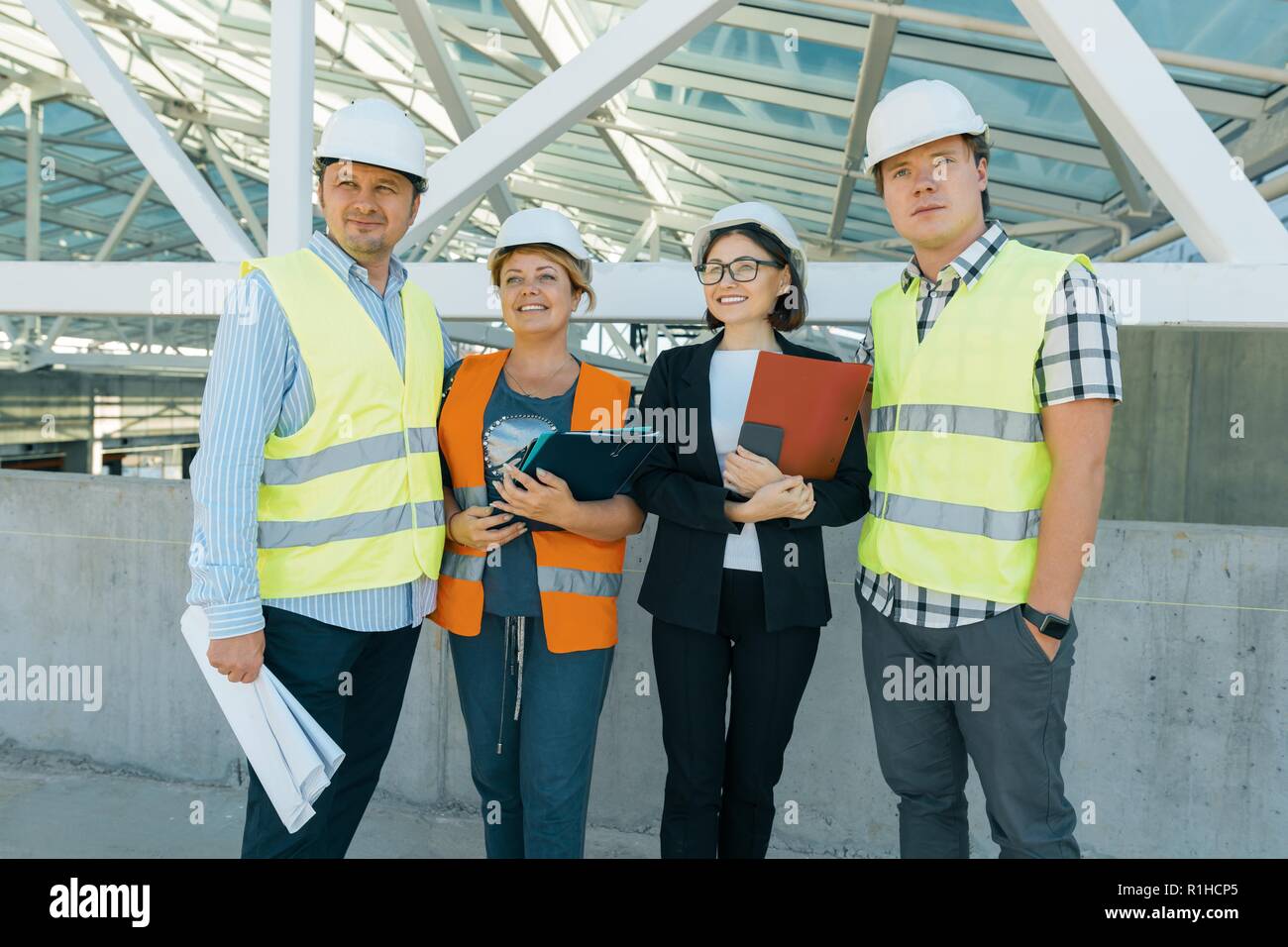 Group of engineers, builders, architects on the building site ...