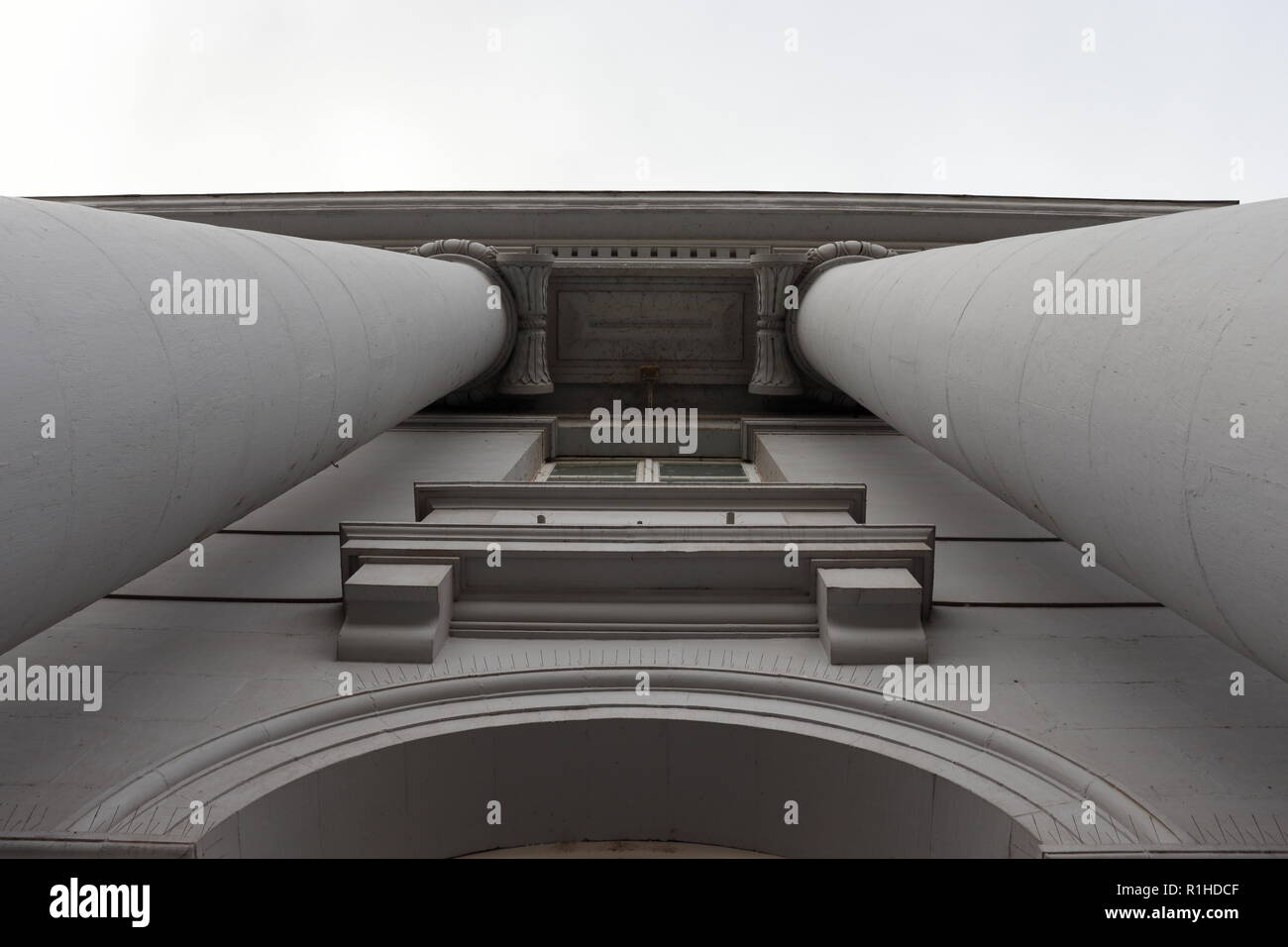A bottom up shot of two stone pillars on either side of an arched ...