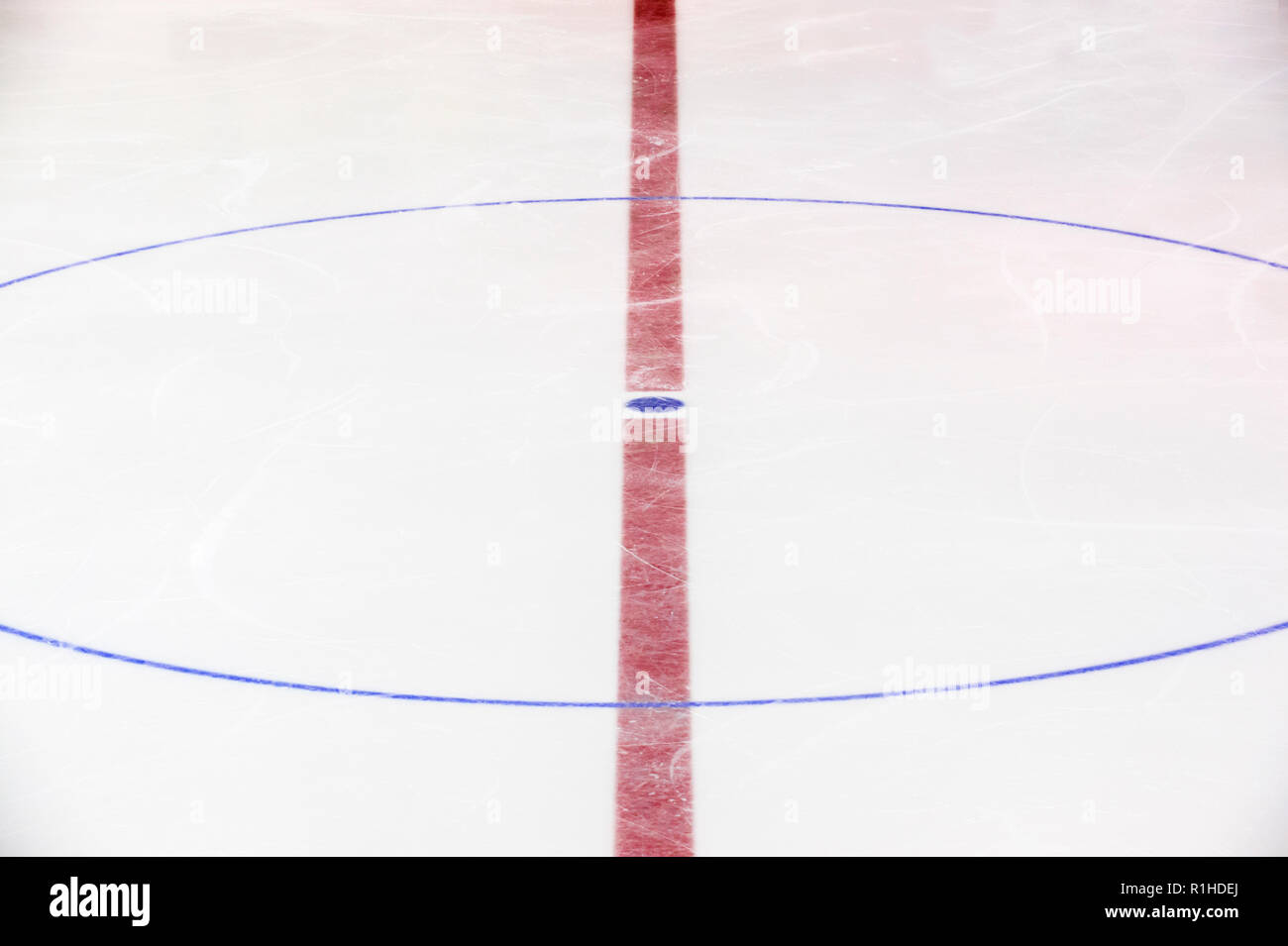 Face off blue spot with red line on hockey rink Stock Photo - Alamy
