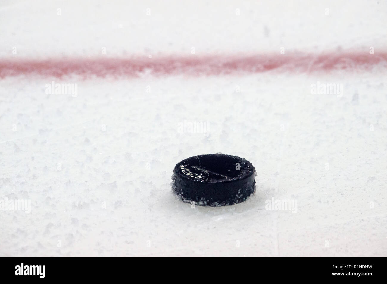 black hockey puck on ice rink. Winter sport Stock Photo - Alamy