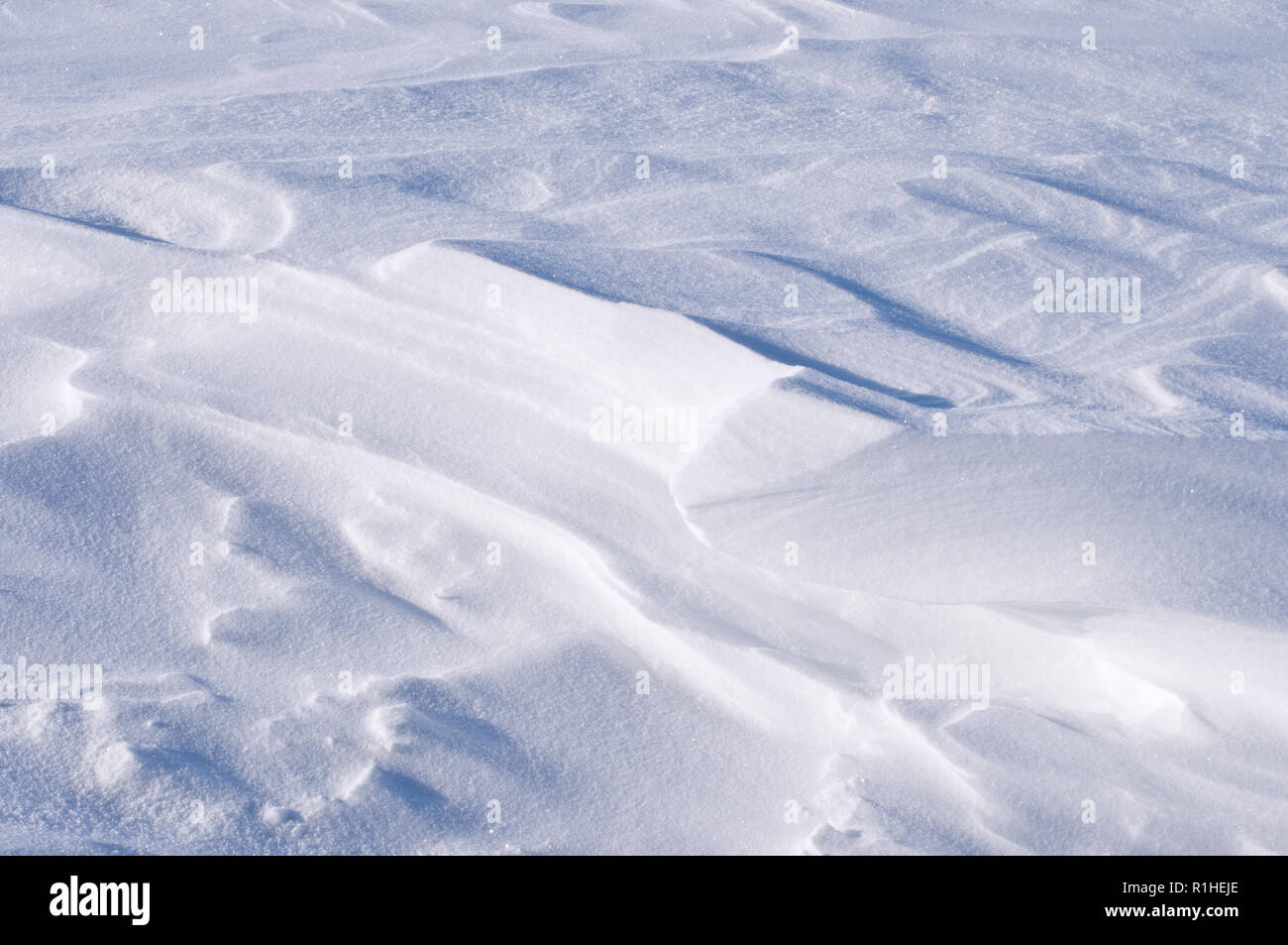 Wind sculpted patterns on snow surface Stock Photo - Alamy