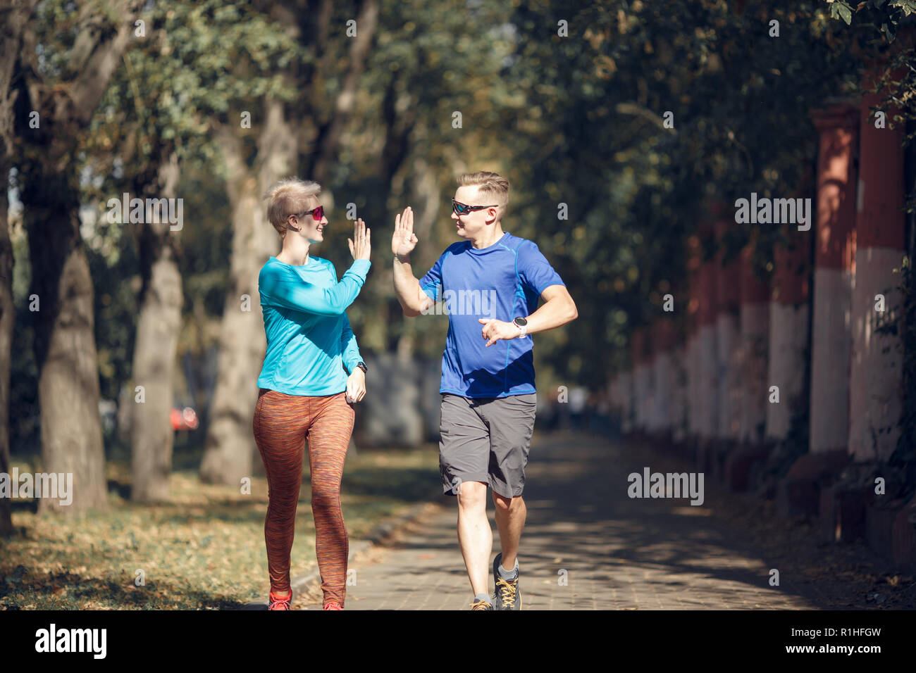 Picture of sporting man and woman doing handshake on morning jog in ...