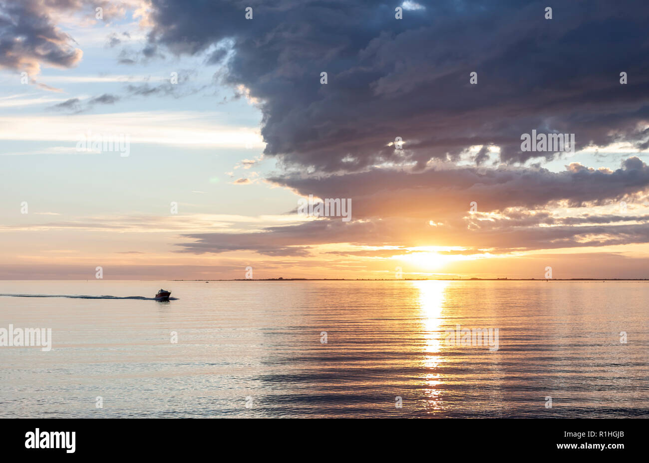 amazing sunset over the sea with dramatic clouds and boat Stock Photo ...