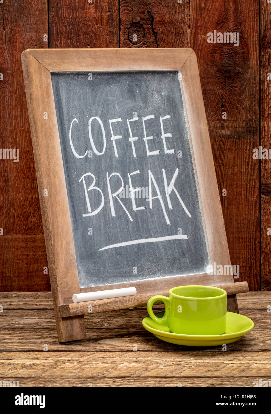 coffee break sign - white chalk handwriting on a blackboard with a cup ...